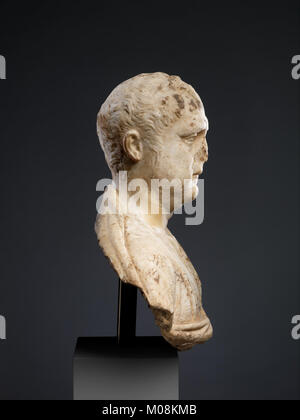 This marble bust depicts a Roman man, emphasizing classical portraiture ...