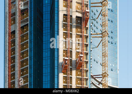 Construction hoists lift elevator for workers and material at the ...