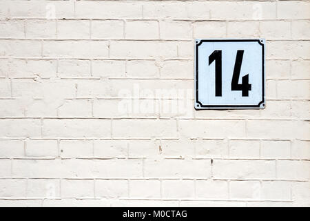 Sign with number 14 on a brick wall Stock Photo - Alamy