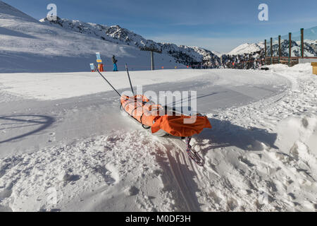 Rescue sled in the snow. Transport sleigh for injured skiers. Prepare ...