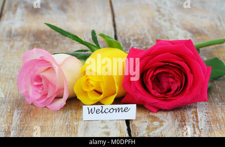 Welcome card with three colorful roses sprinkled with glitter on rustic ...