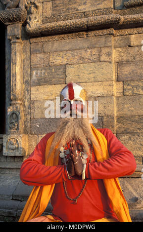 Three-quarter length portrait of a Sadhu with one open hand held up ...