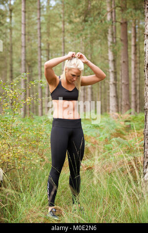 Beautiful blonde girl keeping fit in an outdoor location Stock Photo ...