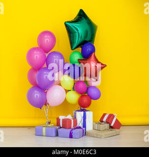 balloons of different colors with gifts for the holiday Stock Photo - Alamy