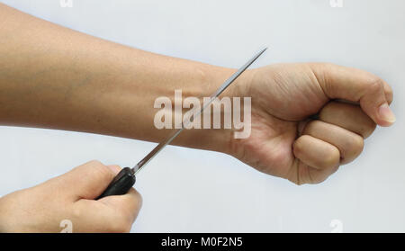 Suicide attempt of a hand with a razor blade Stock Photo - Alamy