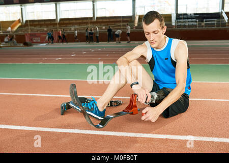 Sprinter sitting with prosthetic leg on Stock Photo - Alamy
