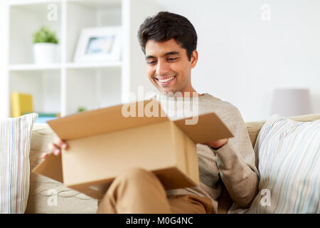 happy man opening parcel box at home Stock Photo - Alamy