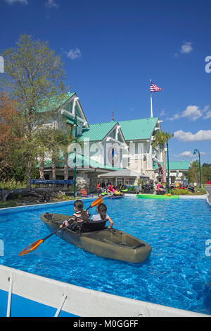 Trying out the kayaks in a temporary pool at a Bass Pro Shops store in ...