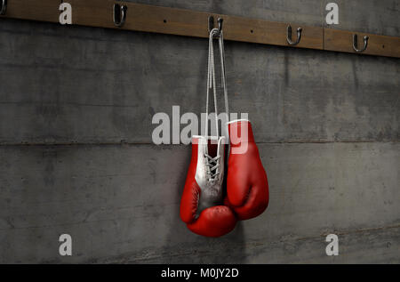 Spotlit boxing gloves hanging on a hanger above an empty wooden bench ...