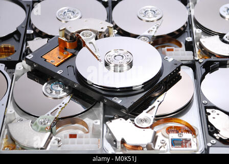 Many Open Hard drives isolated on white background. Are combined by a ...