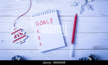 Workplace with a diary, decorations and gifts. New Year's list o Stock ...