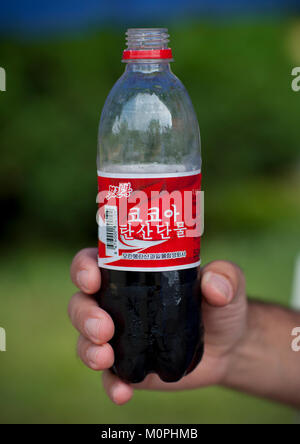 Half full Coca-Cola bottle Stock Photo - Alamy