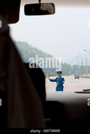 Policeman controlling traffic on the highway Stock Photo - Alamy