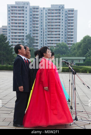 North Korean state artists singing on national day in the street ...