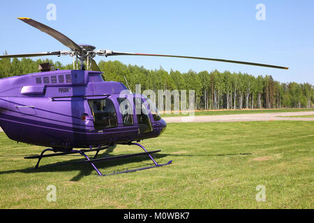 Aircraft - Purple helicopter on the parking against the wood and sky ...