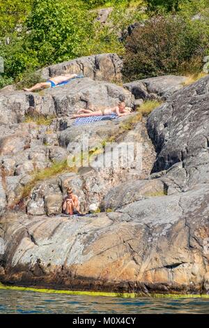 Sweden,Stockholm,tanning on the rocks Stock Photo - Alamy
