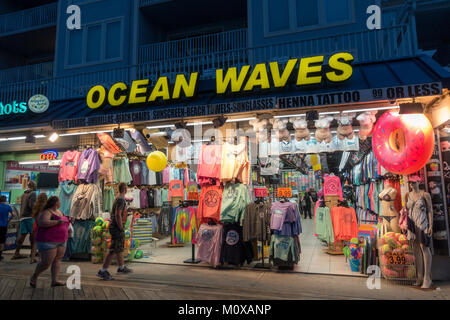 A souvenir store on an ocean boardwalk selling shirts and other items ...