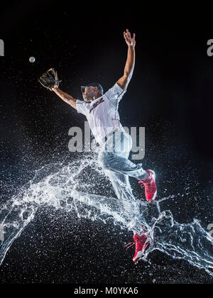 Water splashing on Black baseball player swinging bat Stock Photo - Alamy