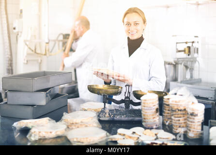 Woman standing with box of turron at factory Stock Photo - Alamy