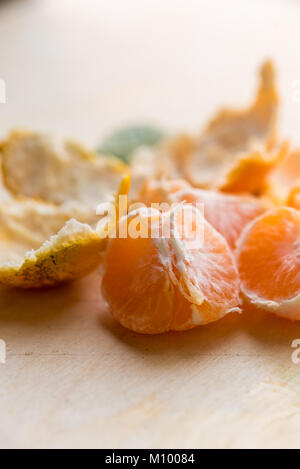 peeled ripe juicy tangerine, divided into slices of tangerine on a ...