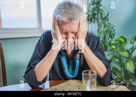 Sad mature woman experiencing pain in the shoulder isolated on white ...