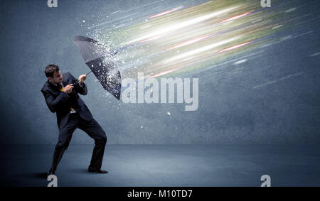 Business man defending light beams with umbrella concept Stock Photo ...