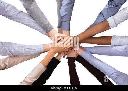 Elevated View Of Hands Stacking Each Other Hands Against White ...