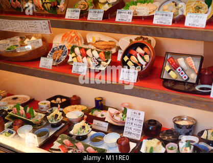 Plastic food models (shokuhin sampuru) in glass cabinet outside ...
