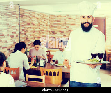 Chef taking care of adults at cafe table Stock Photo - Alamy