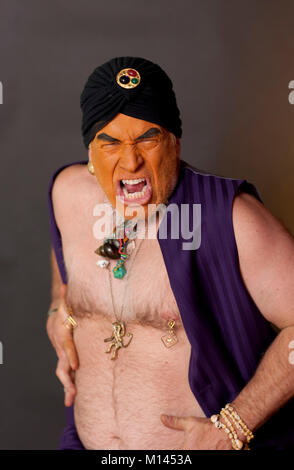 Angry, orange faced man in a purple vest and black turban Stock Photo ...