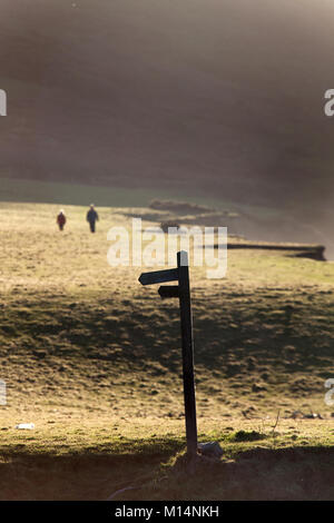 The Wales Coast Path. Silhouetted view of a route sign on the Wales and ...