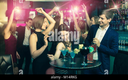 Happy positive glad colleagues dancing on corporate party with ...