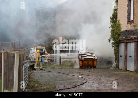 Fire Brigade attending a skip fire in North Wales Stock Photo - Alamy