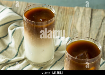 Refreshing Homemade Layered Iced Coffee with Milk Stock Photo - Alamy