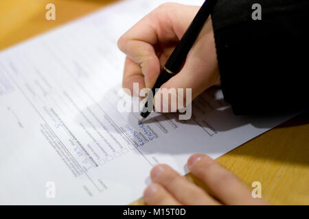 Young woman completes job application form paperwork write information ...