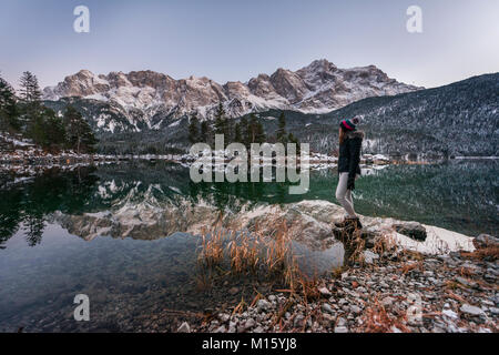 Woman at lake Eibsee, mountains Zugspitze, Grainau, Bavaria, Germany ...