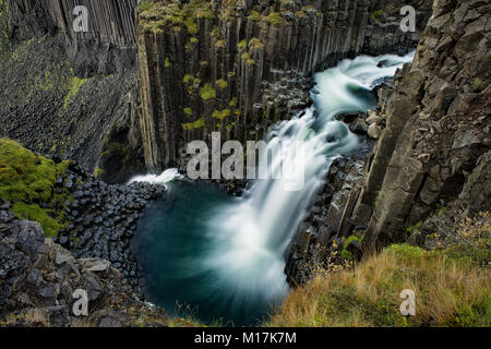 Litlanesfoss waterfall and river flowing between basalt columns Stock ...