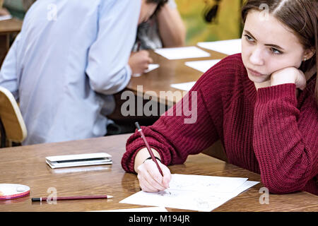 Primary school teacher engaging a group of students in a collaborative ...