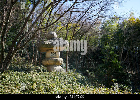 Traditional Japanese stone lantern (toro) in the temple garden ...
