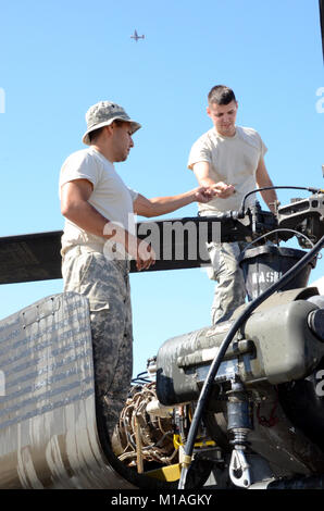 U.S. Army aircraft maintainers scrub down a UH-60 Black Hawk helicopter ...