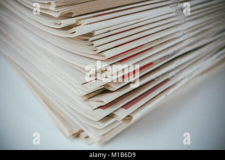 Stack of newspapers placed on white background Stock Photo - Alamy
