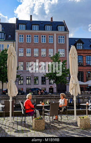 Two women drink water and wine @ wine waiter pours wine @ serve ...