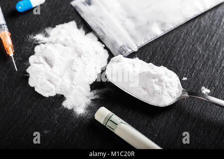 White powder in form of cocaine drugs under Ben Franklin nose and mouth ...
