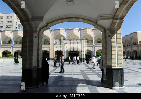 Iranian people walk by the streets of Mashhad near the Imam Reza shrine ...