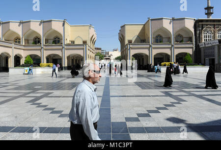 Iranian people walk by the streets of Mashhad near the Imam Reza shrine ...