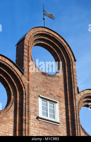 Closeup of house roof top with attic windows covered with snow in cold ...