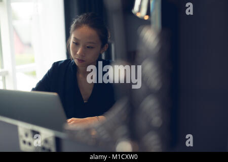 Beautiful woman is using laptop while sitting on back seat Stock Photo ...