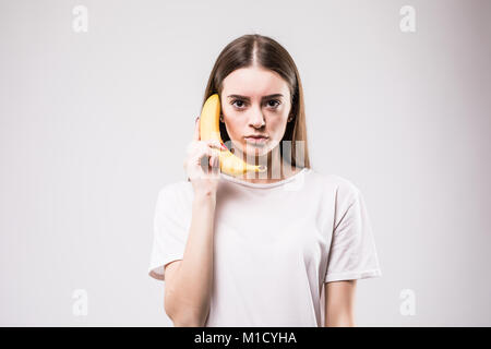 woman calling with a banana on a white background Stock Photo - Alamy