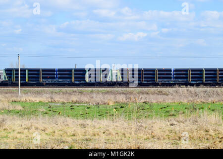 Freight train, carrying pipes for the gas pipeline and other freight ...