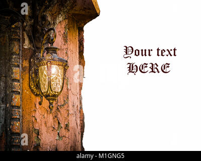 An ancient beautiful wall lamp hangs on the wall of the old building ...